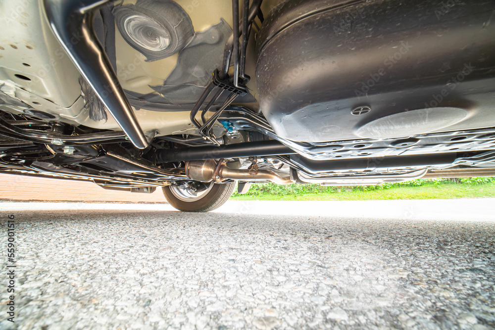 View of the car by auto mechanic from below. Automobile exhaust system ...