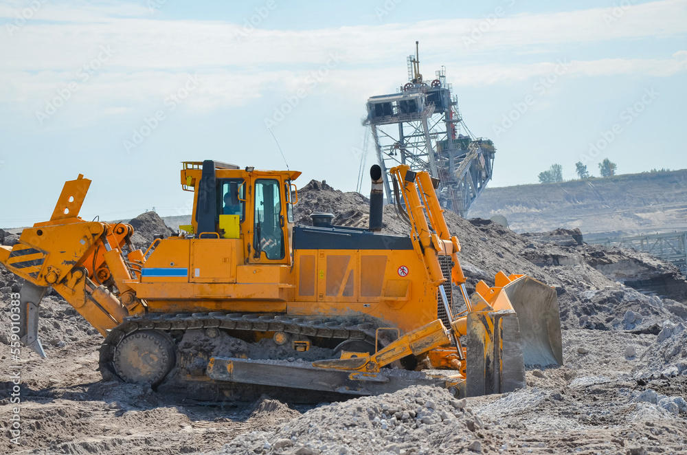 Crawler dozer working on construction site or quarry. Mining machinery ...