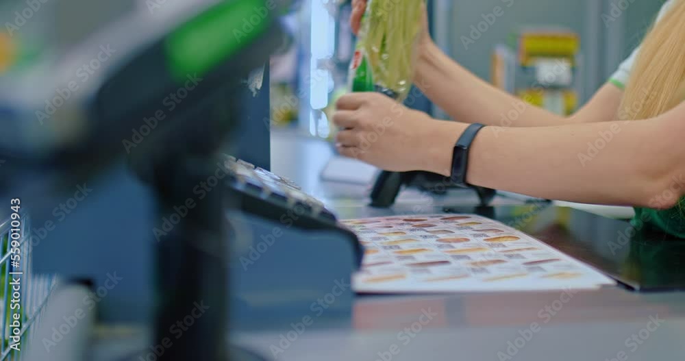 scanning goods by barcode in supermarket, cashier woman serving ...