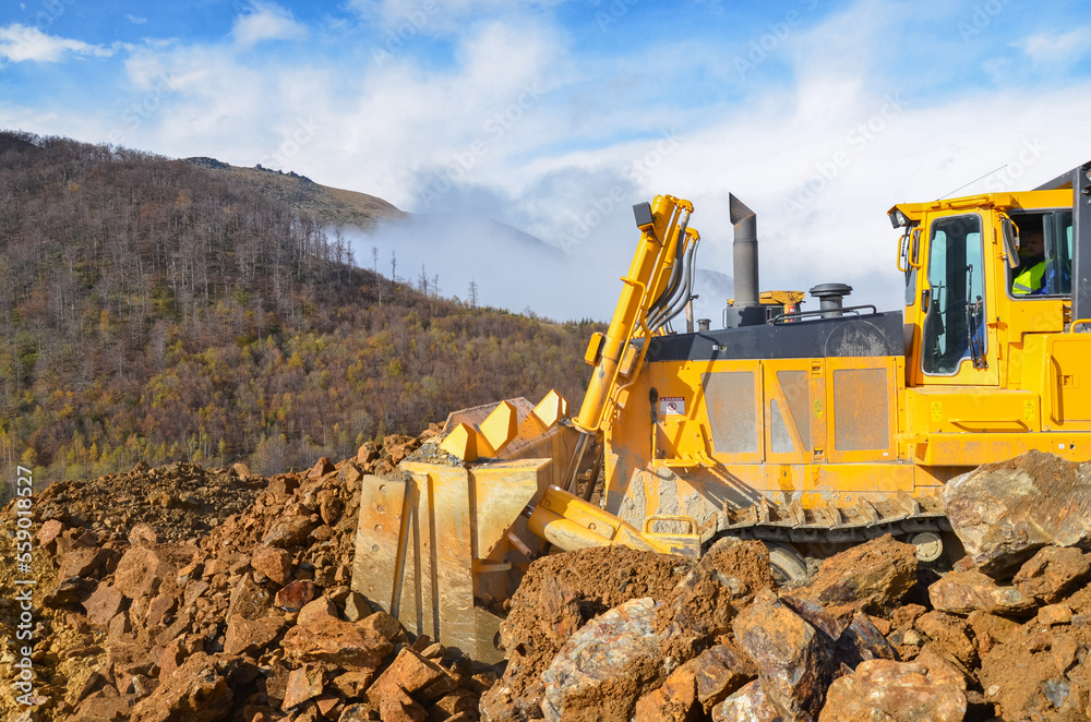 Big crawler dozer working on construction site or quarry. Mining ...