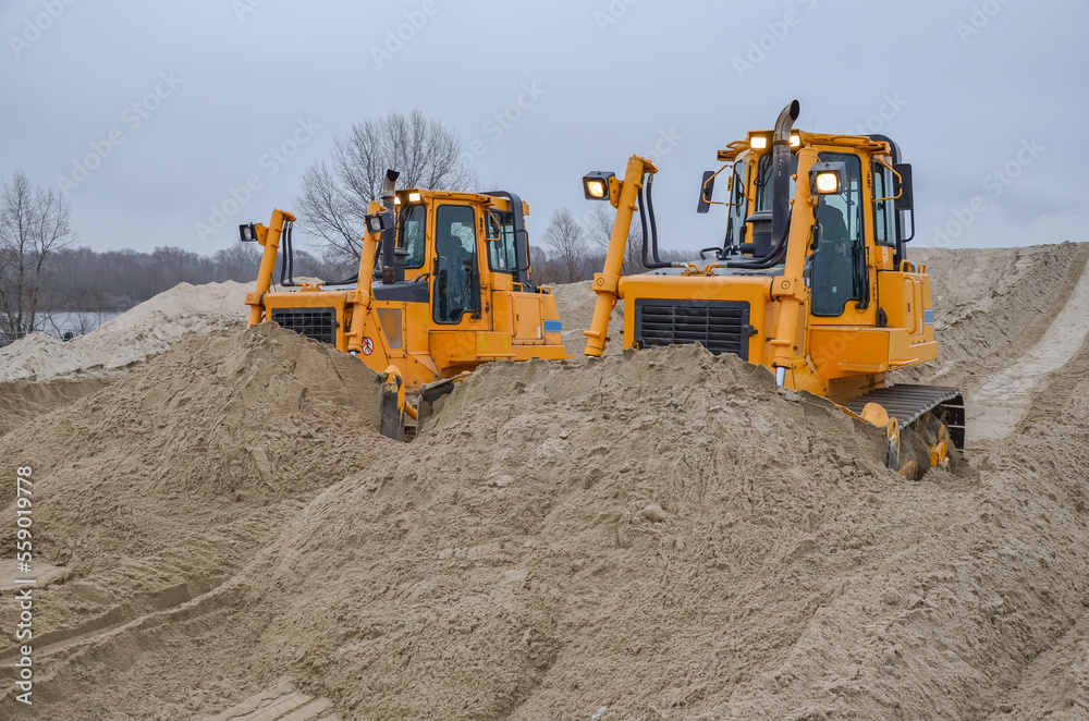 Crawler bulldozers working on construction site or quarry. Mining ...