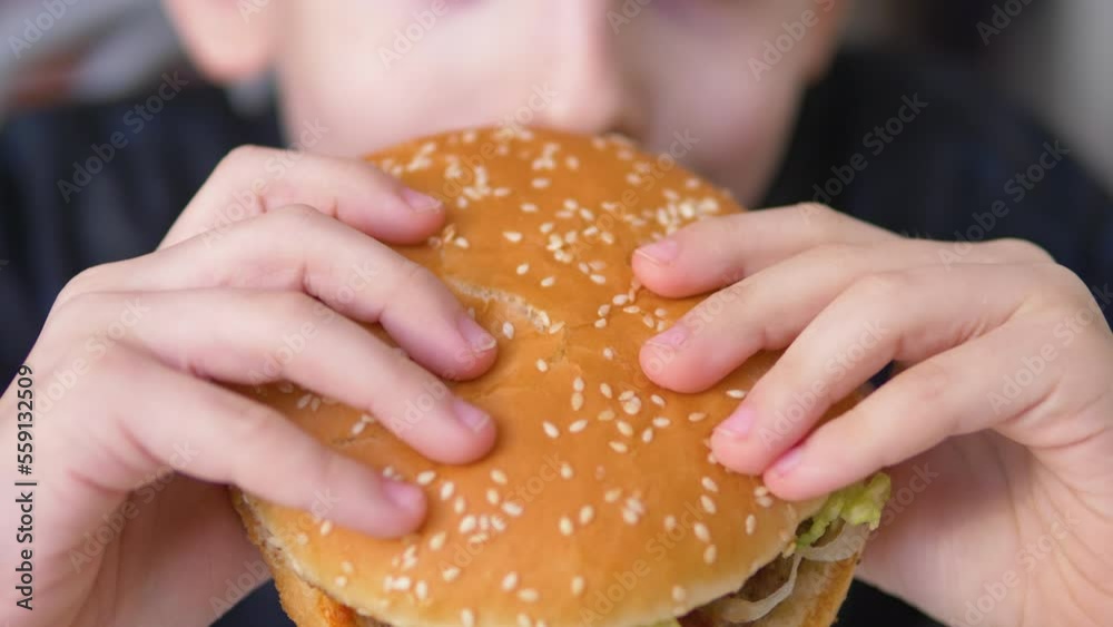 close-up big burger sniffing and enjoying the smell caucasian boy in ...