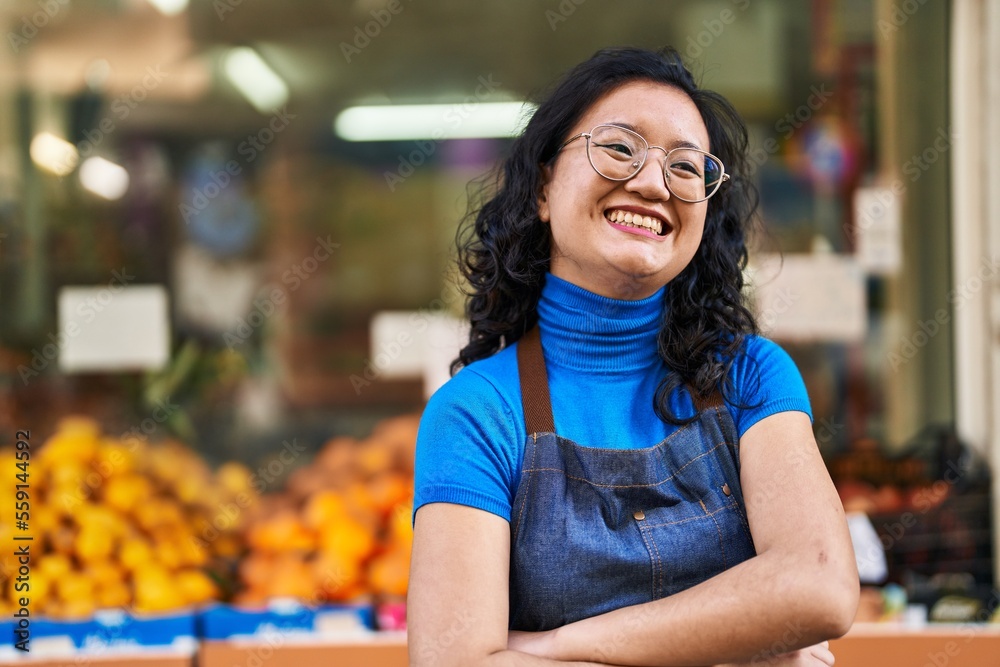 Young chinese woman employee smiling confident standing with arms ...