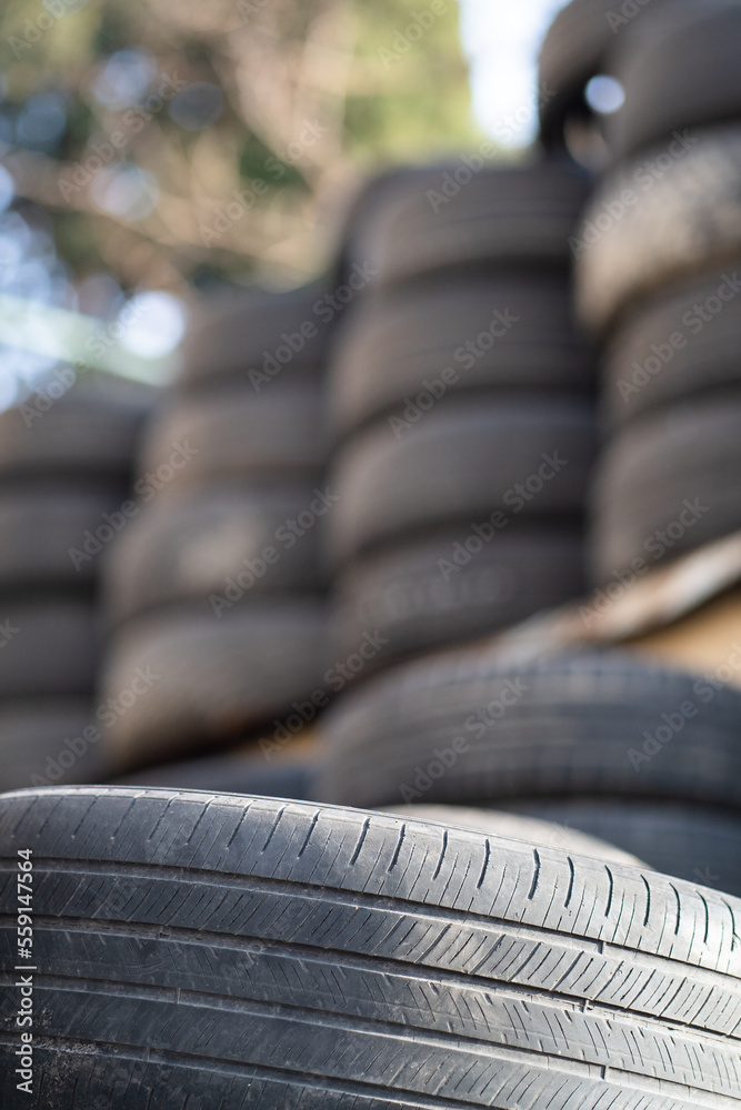 Old used rubber tires stacked with high piles. Tyre dump. Hazardous ...
