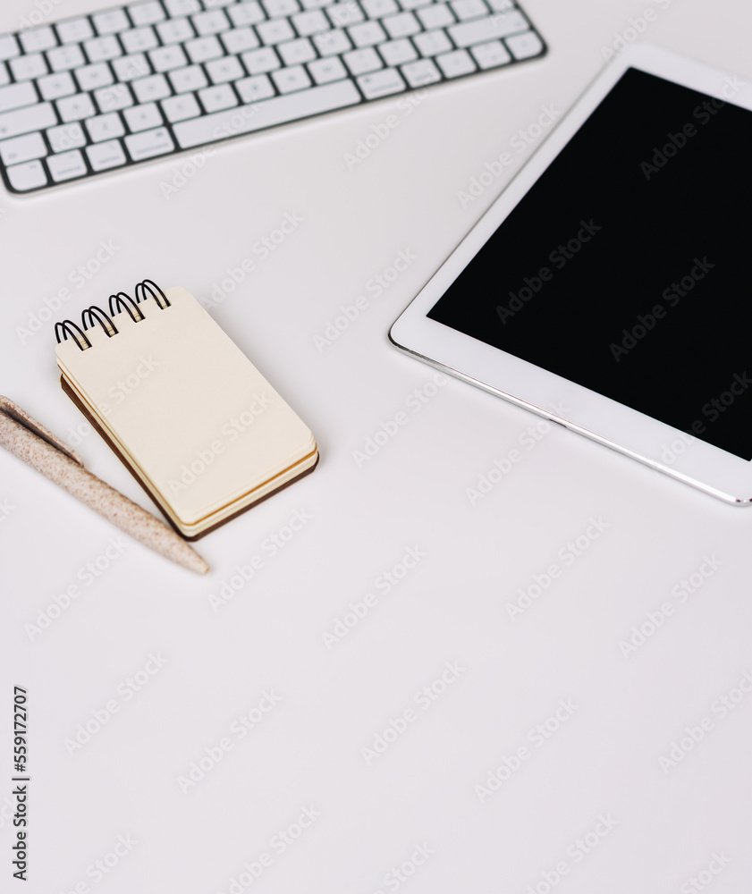 Blank notepad digital tablet and keyboard on top of desk still life ...