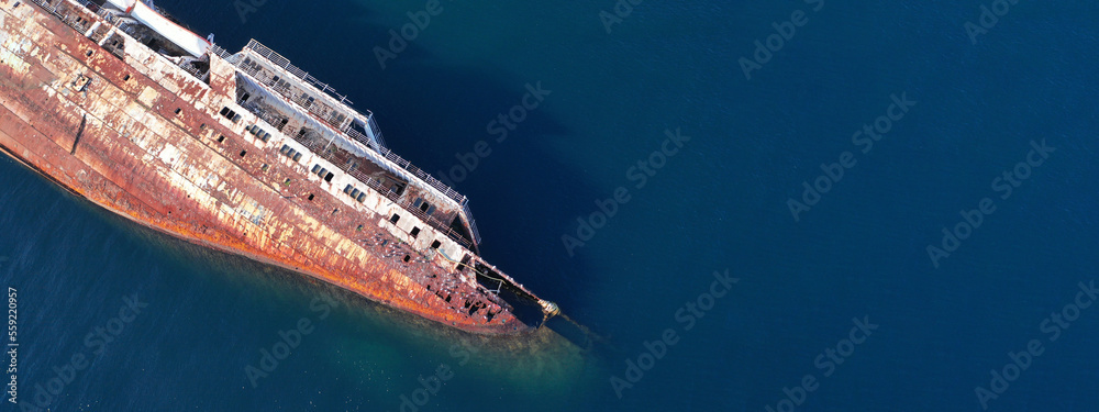 Aerial top down ultra wide photo of capsized abandoned passenger ship ...