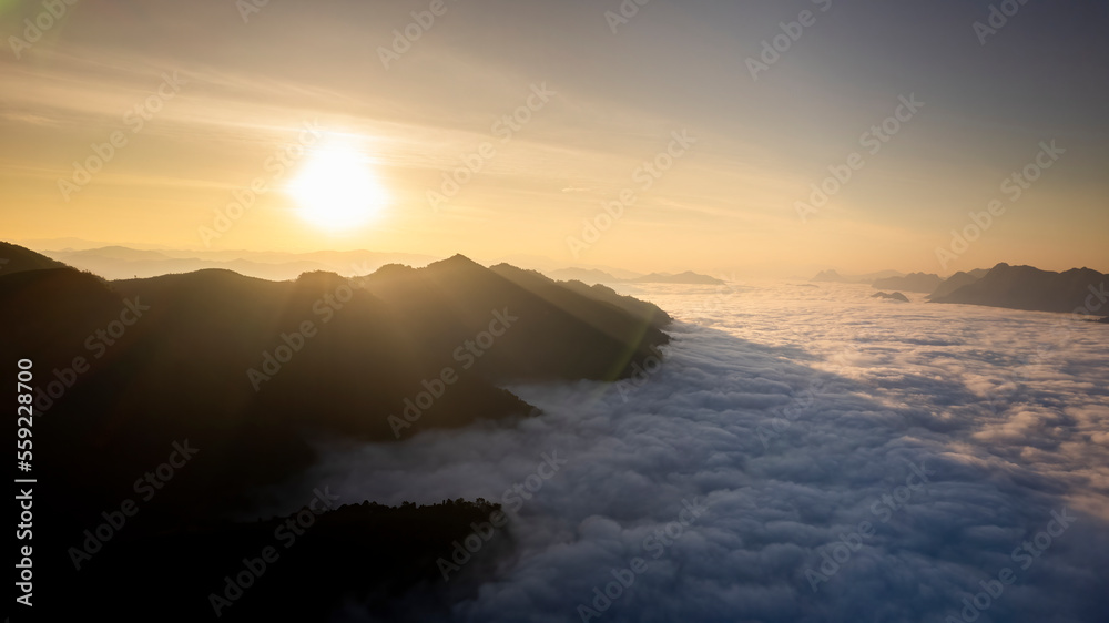 Amazing sun rise over mountain against white sea of clouds or mist over ...