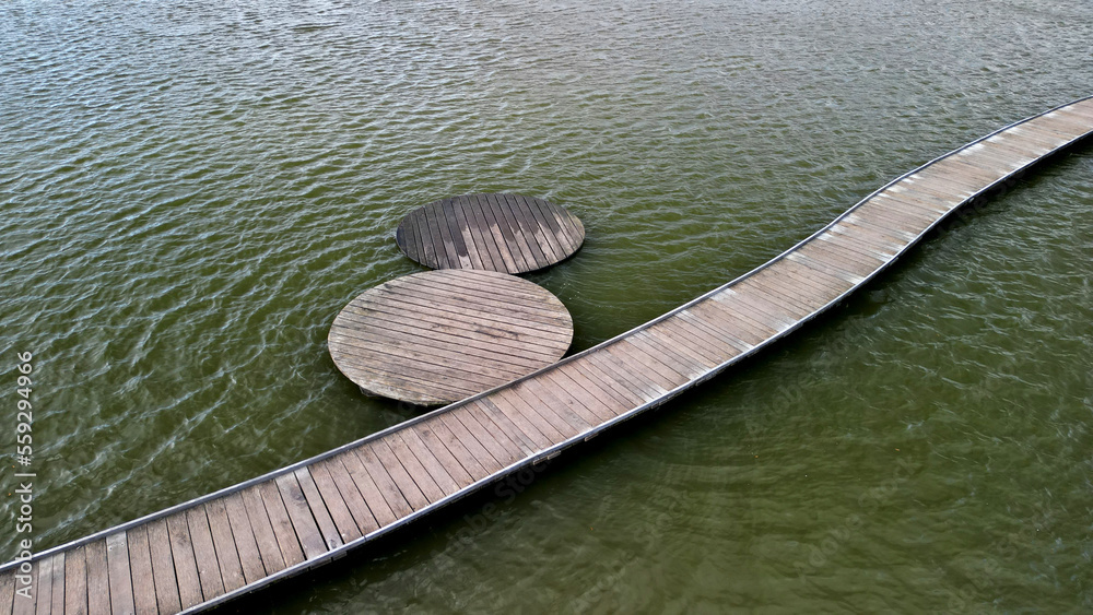 floating walkway made of wooden planks. narrow curved paths on stilts ...
