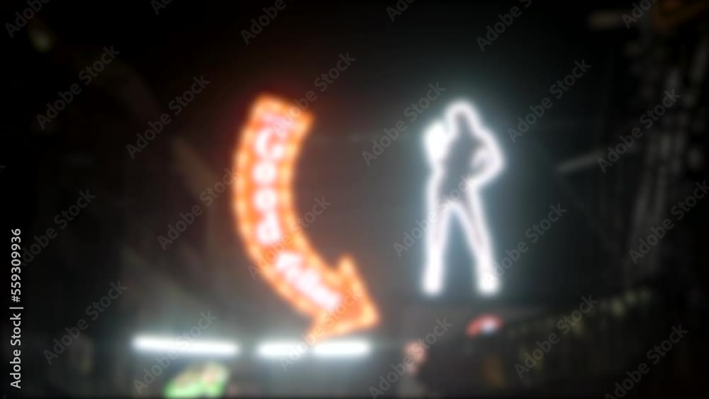 Blurred good fellas sign with lady shape neon light at red light ...