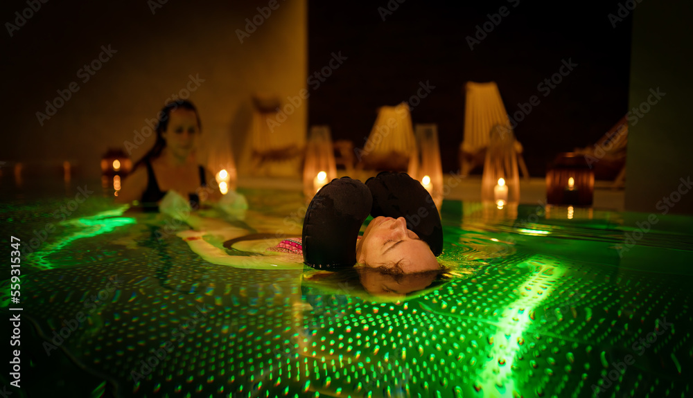 Therapeutic exercise in the pool. Woman receiving an aquatic therapy in ...