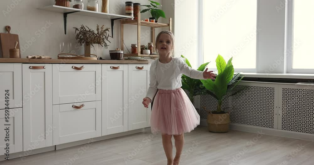 Beautiful little 5s girl moving, jumping, having fun in modern warm ...