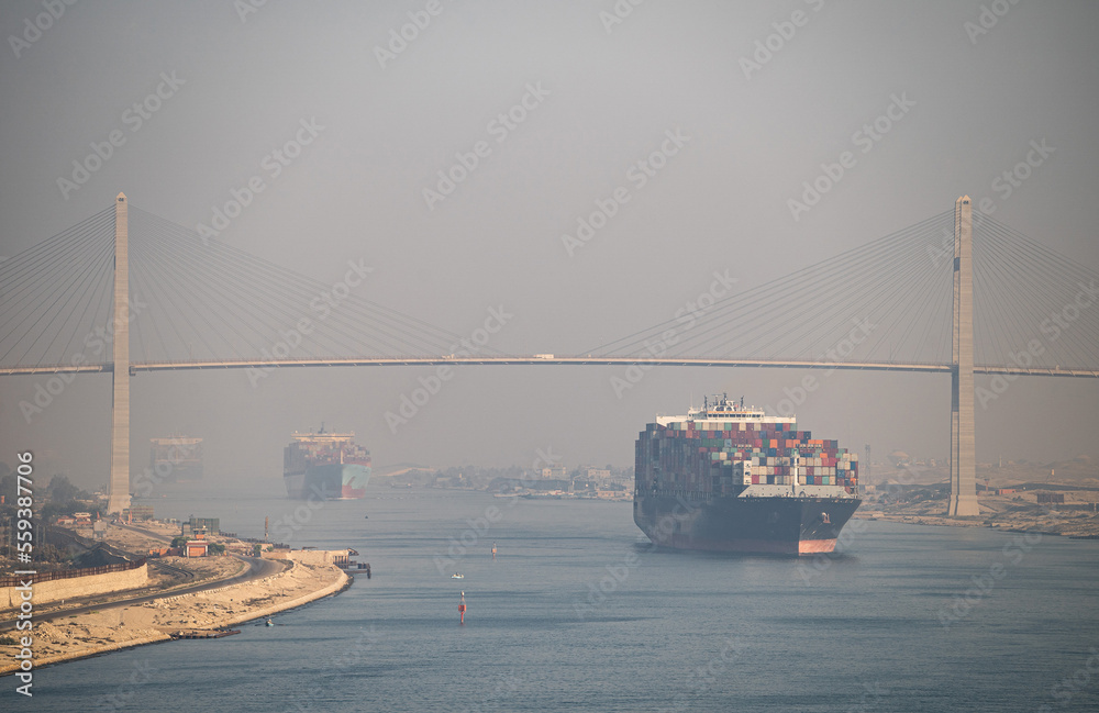 Many cargo ships navigate through Suez Cana andder Al Salam Bridge. Concept of transportation ...