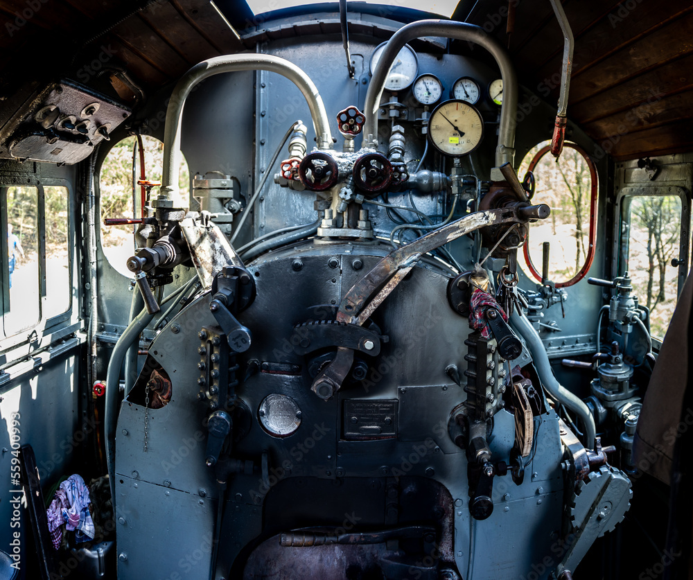 A set of pressure gauges and other gauges on a steam locomotive boiler ...