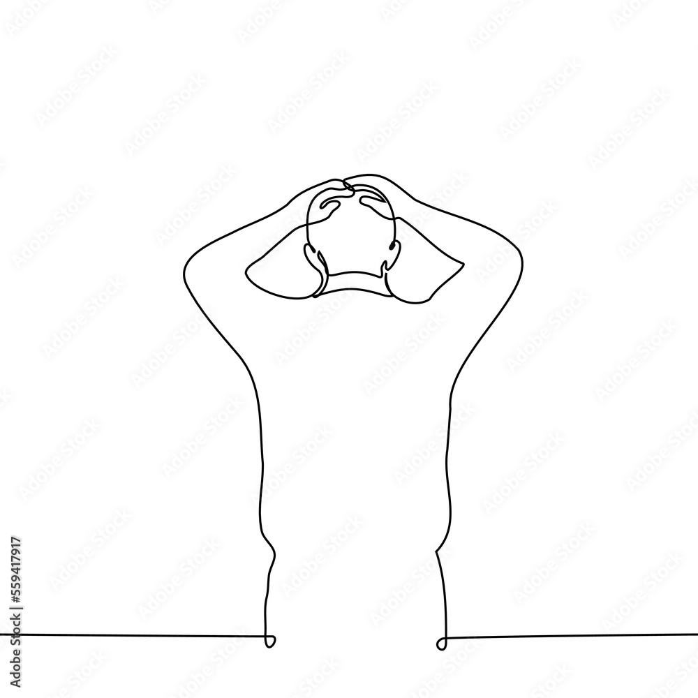 man grabbed his head with both hands while standing with his back to ...