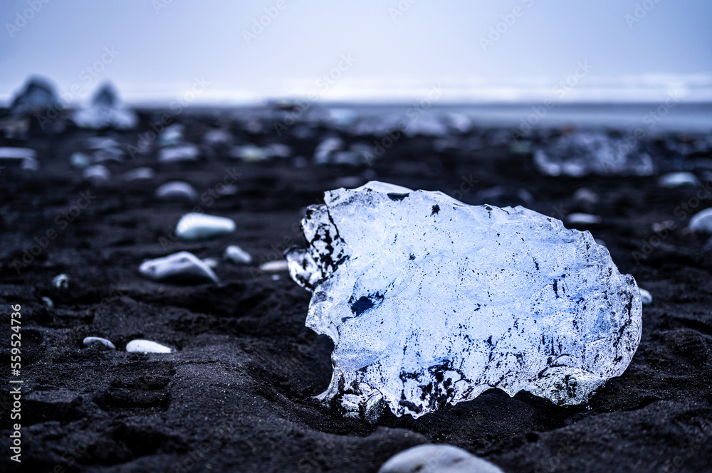 Diamond Beach in Iceland with blue icebergs melting on the black sand ...