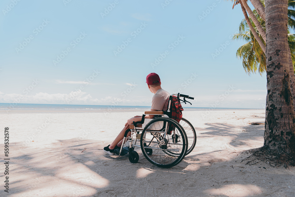 Foto de Back of young man with disability wearing a red cap on ...