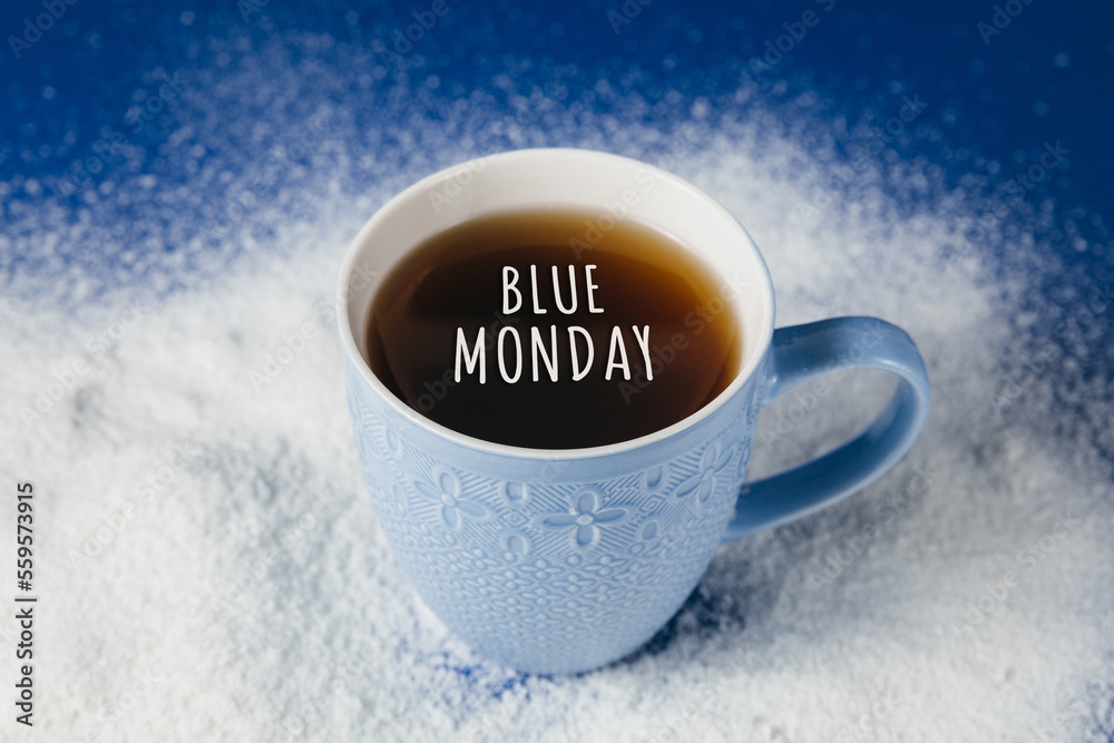 Cup of tea with snow on a blue background with "Blue Monday" lettering ...