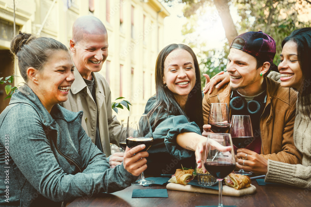 Happy friends having fun drinking red wine outdoors at winery bar ...