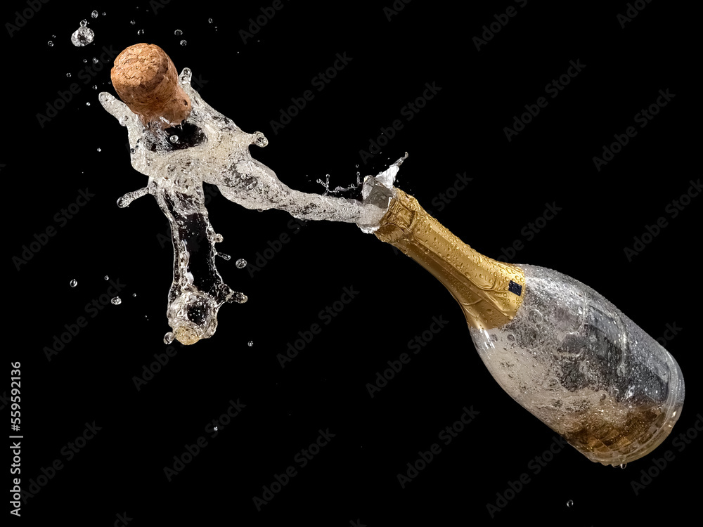 Champagne bottle pops out and splash on black background Stock Photo ...