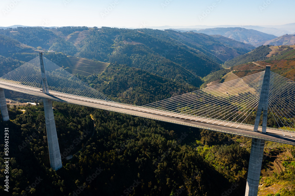 Scenic aerial view of vehicular suspension bridge supported by concrete ...