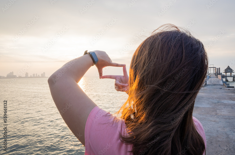 Asian female tourist making a square with her hands tourist attractions ...