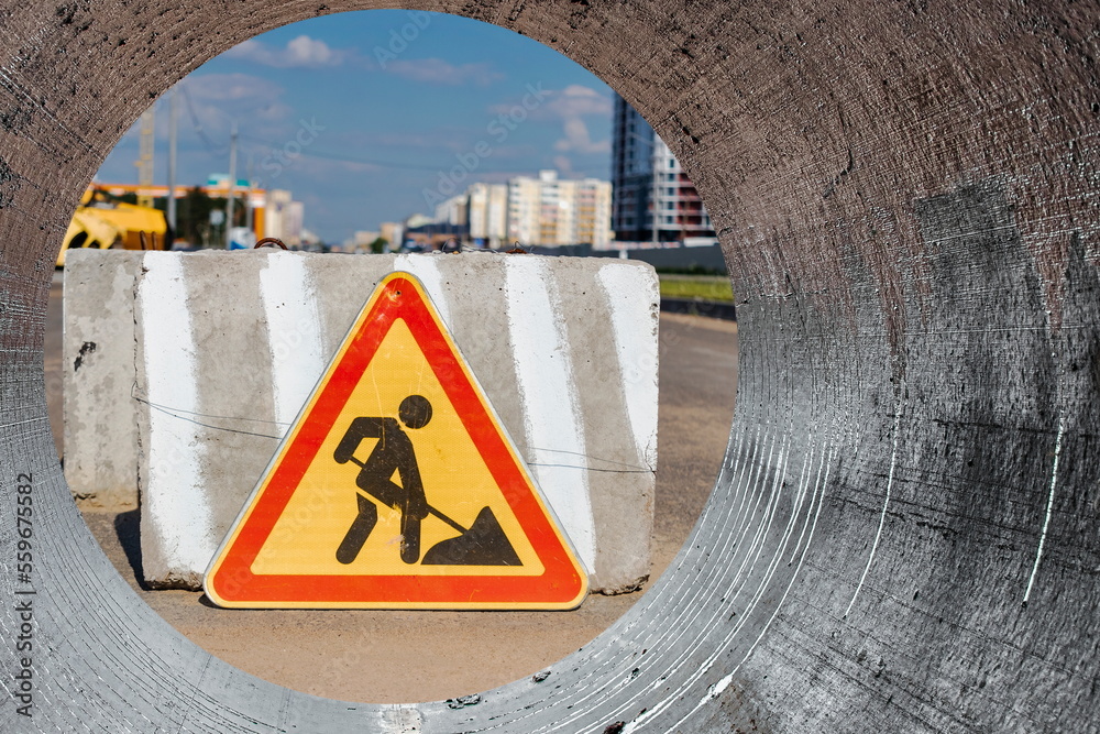 A stop road sign and concrete blocks block the entrance to the ...