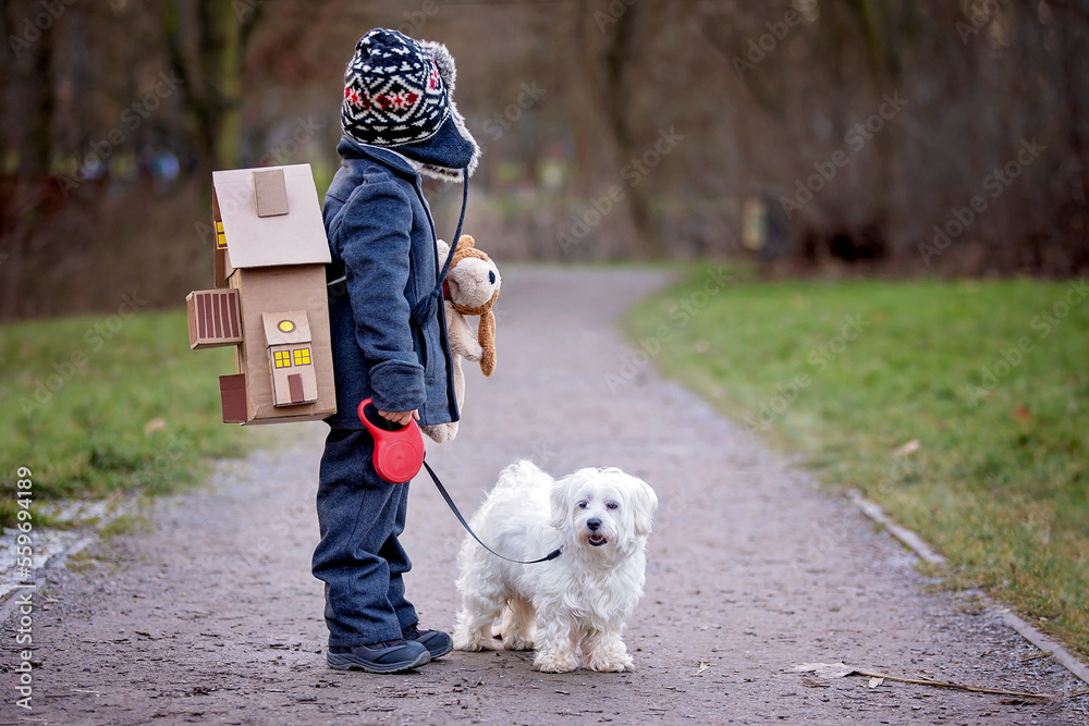 Little child, blond boy with pet dog, carying home on his back, kid ...