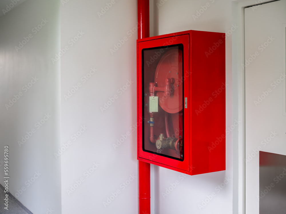 Fire extinguisher cabinet mounted on the wall in the corner of the ...