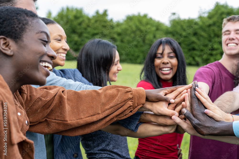 Joined hands and happy friends, peace and love concept, close up of ...