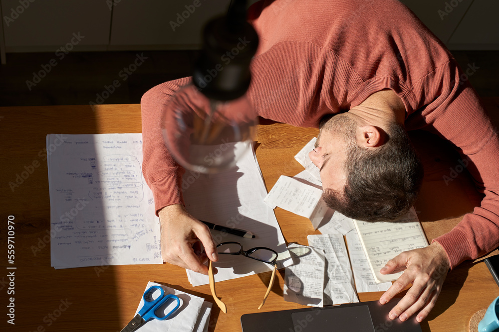 Tired man sleeping on documents at desk Stock Photo | Adobe Stock