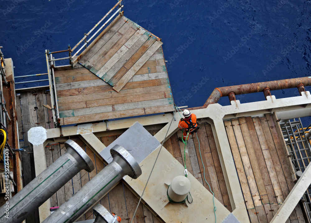 overhead view of an offshore rigger preparing a platform to accomodate ...