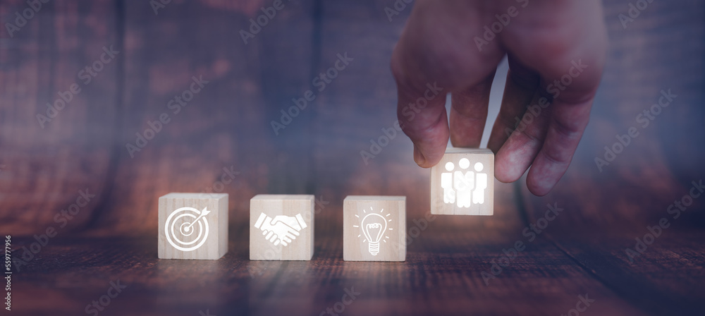 the concept of team work to be success, wooden blocks with icons and ...