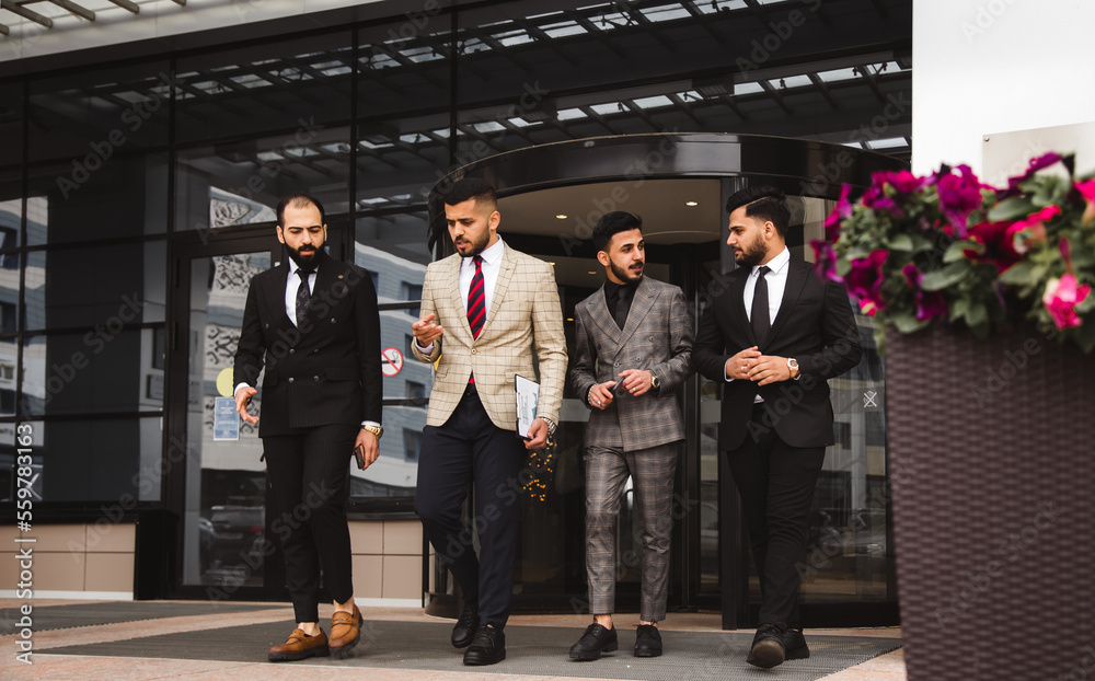 Business people outdoor meeting. A group of male businessmen in suits ...