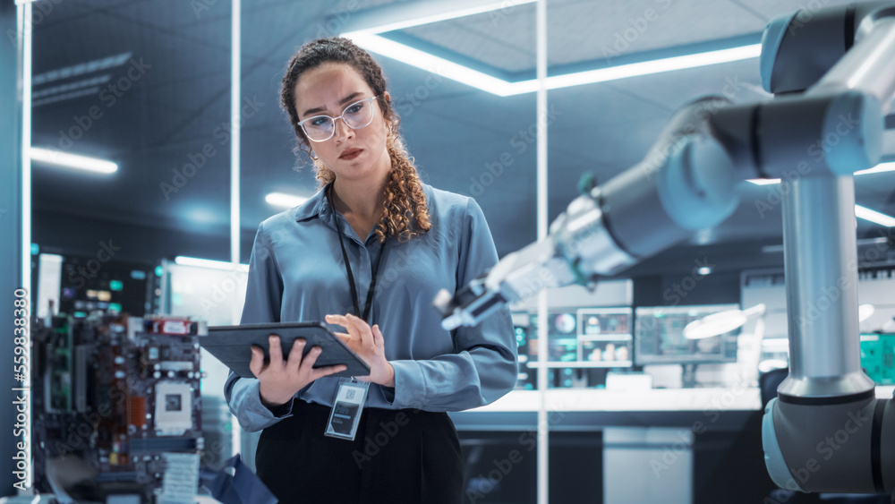 Industrial Robotics Engineer Interacting With Robotic Arm During An