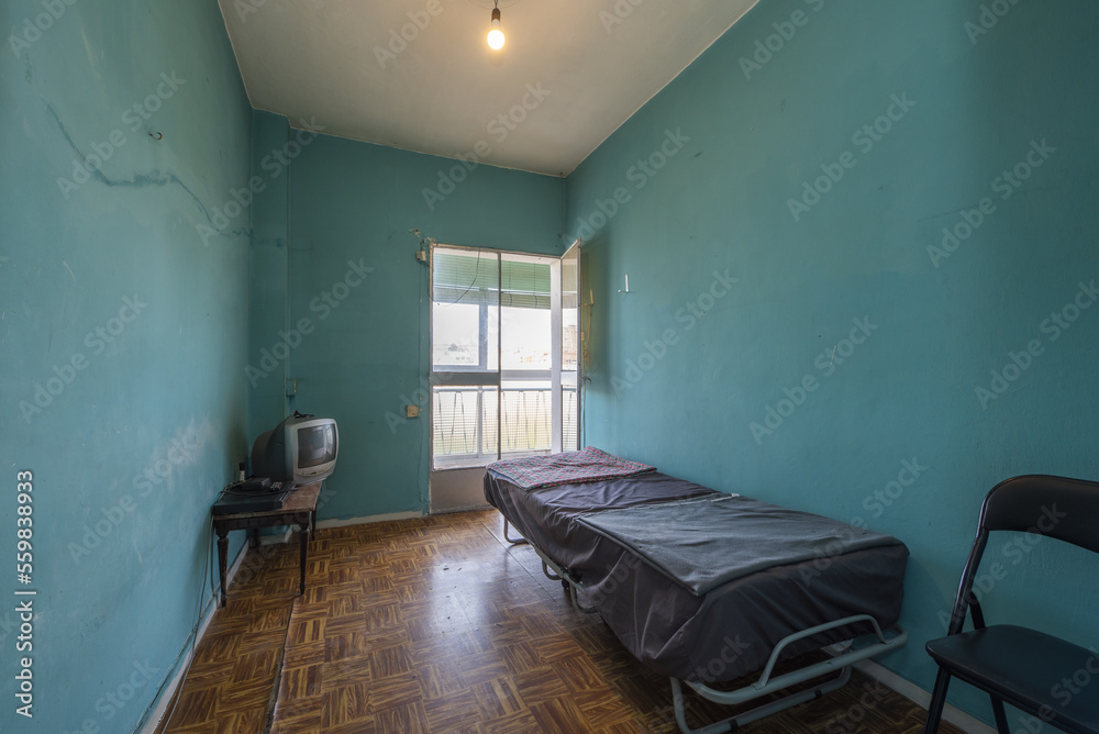 Shabby room painted ugly blue years ago with an individual gray metal ...