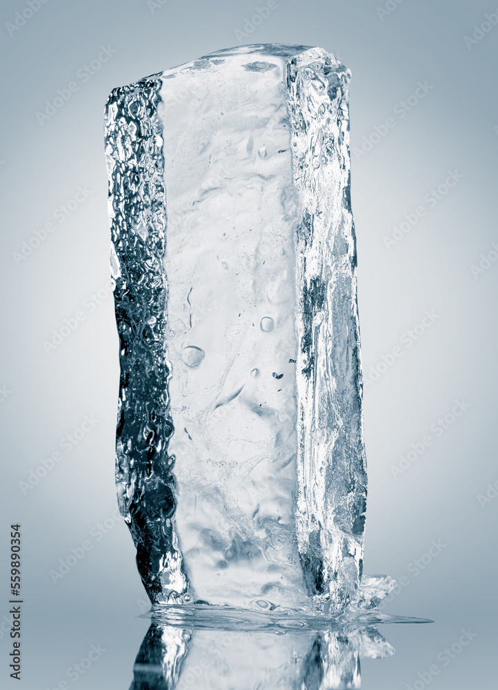 Crystal clear natural ice block in light blue tones on a white ...