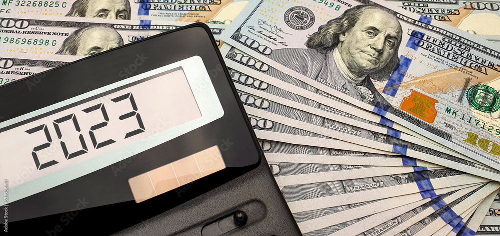 Calculator with the number 2023 on the screen against the background of ...