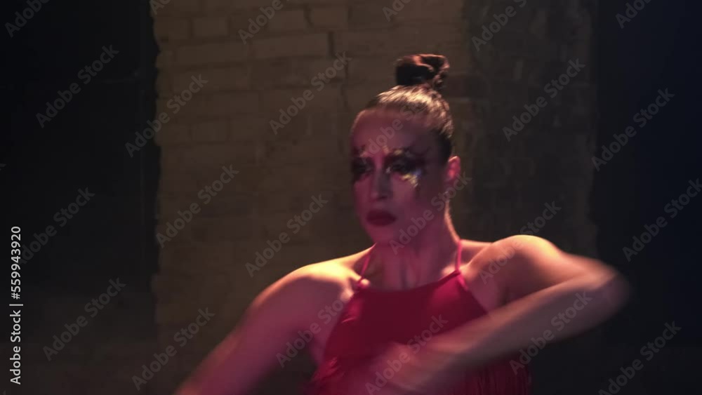 Close-up side view of beautiful dancing actress with stage makeup of ...