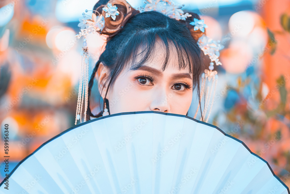 Portrait Cute Asian Girl wearing Chinese costumes and hold chinese fan ...