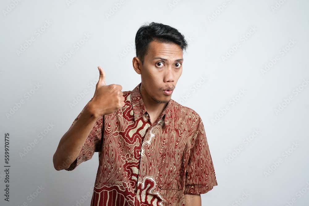 young asian man with brown skin wearing a batik shirt happy expression ...