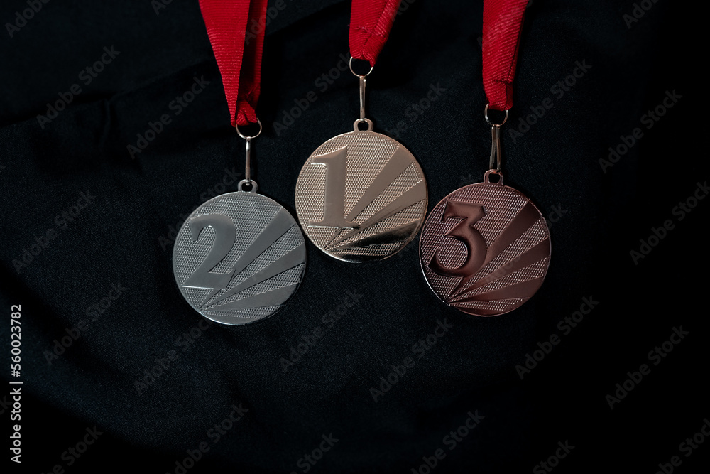 Gold, silver and bronze medals with numbers on black isolated ...