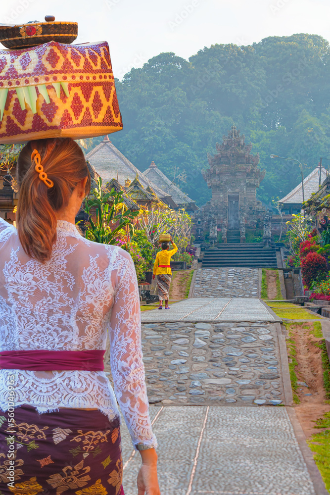 Beautiful balinese girl in traditional costume walking - Penglipuran is ...