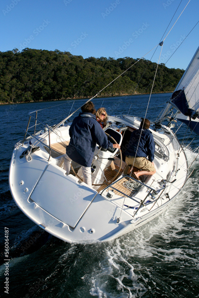 Trimming the sails on a yacht cruising on the North Shore from Sydney ...