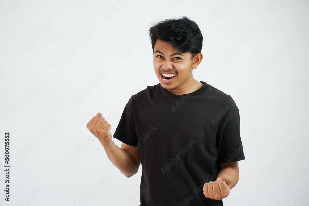 Confident cheerful handsome asian man lifting hands up wearing black t ...