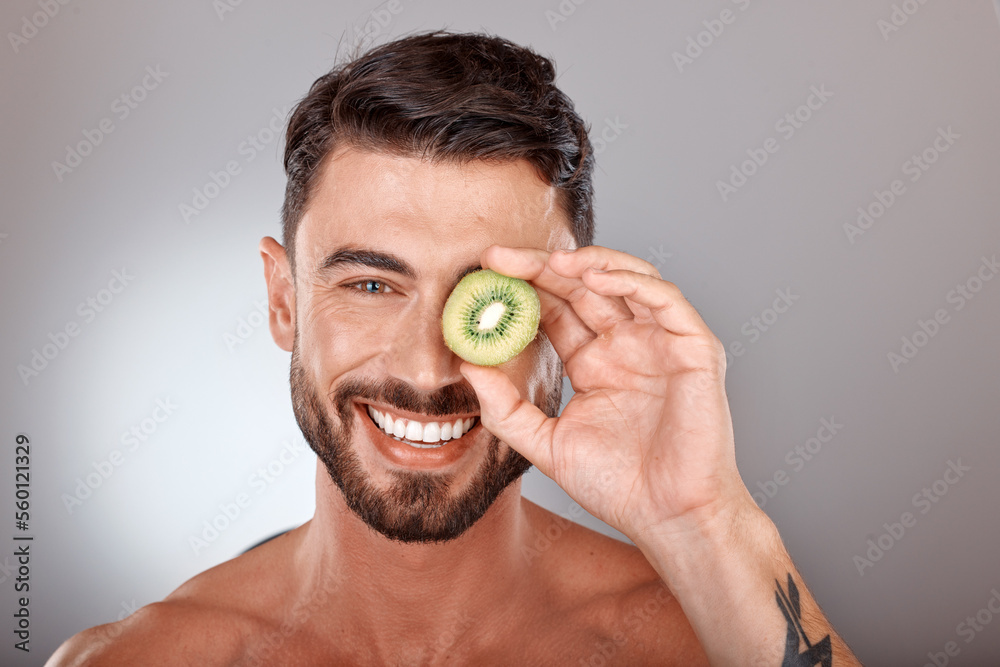 Man, face and beauty with kiwi, facial care with wellness and organic ...
