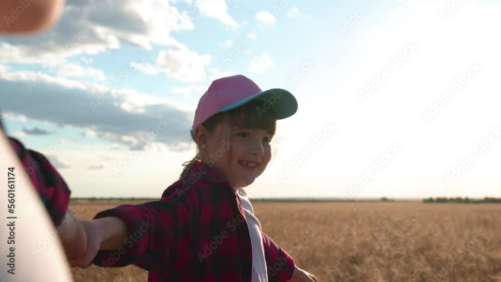 Little girl and boy run hand in hand across field. Concept of childrens ...
