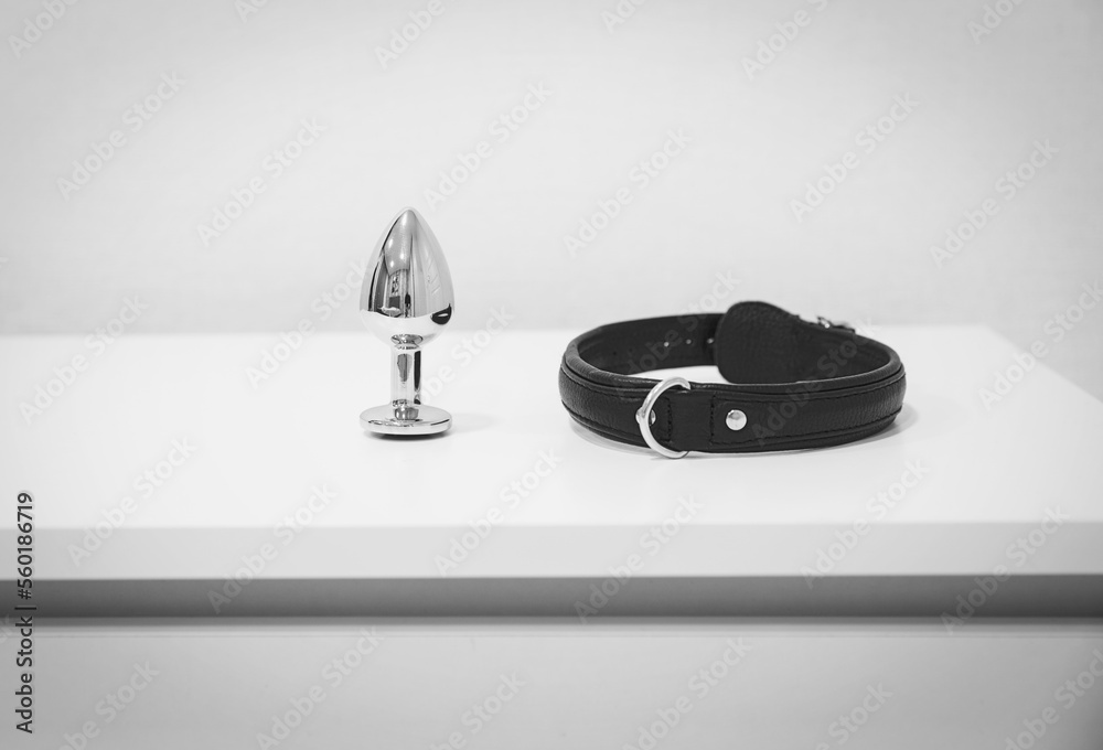 Paddle, collar and anal plug on the table. Domestic discipline. Traditional corporal punishment ...