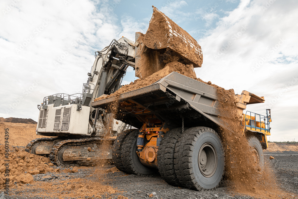 Large quarry dump truck and excavator. Big mining truck work coal ...