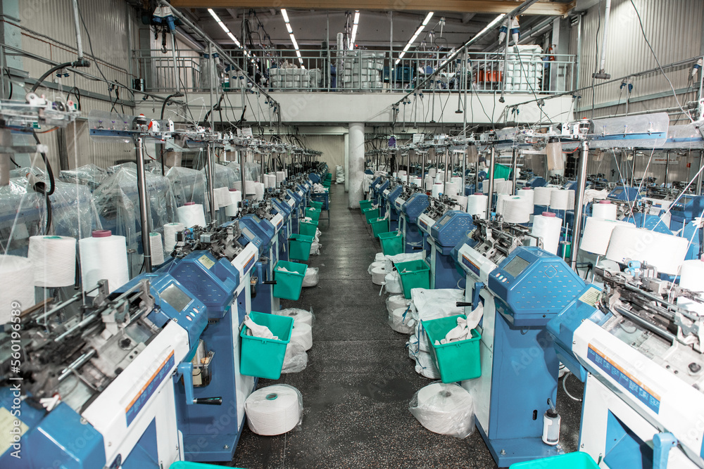 Interior of garment factory shop. Textile workshop with sewing machines ...