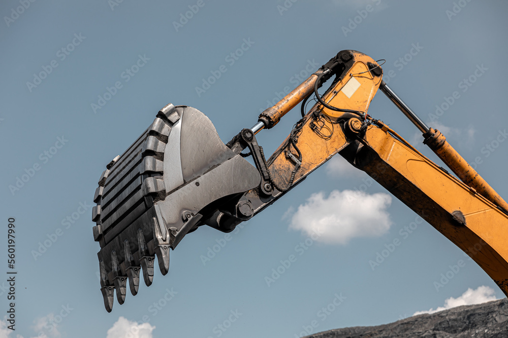 Large quarry dump excavator. Big yellow mining excavator at work site ...